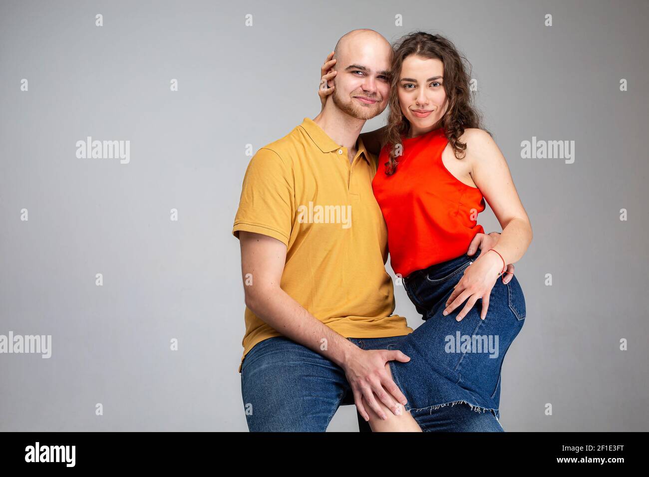 White young european people sitting isolated on gray Stock Photo - Alamy