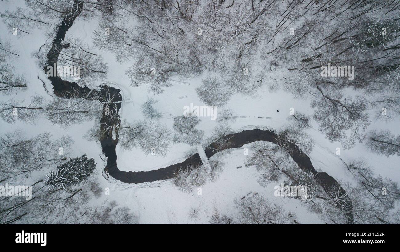 Aerial winter landscape. Tiny river between snowy forest Stock Photo ...
