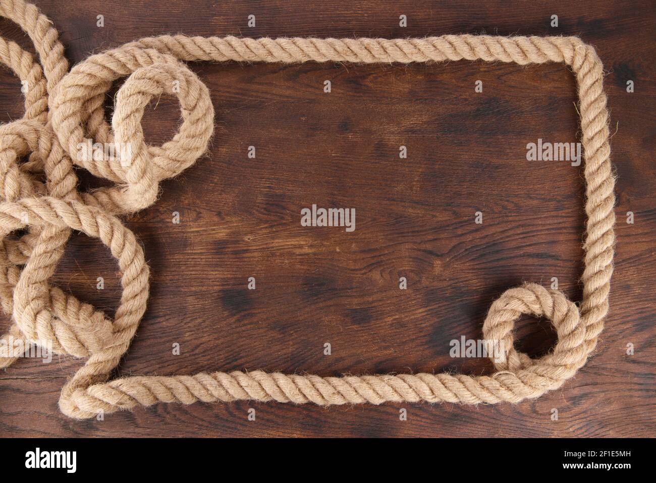 Strong Rope Frame on wooden Background Stock Photo - Alamy
