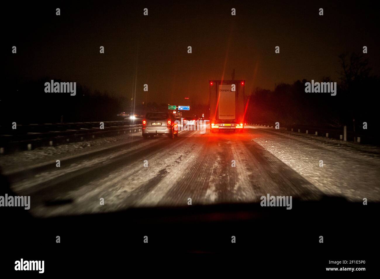 A snowy road at night Stock Photo - Alamy