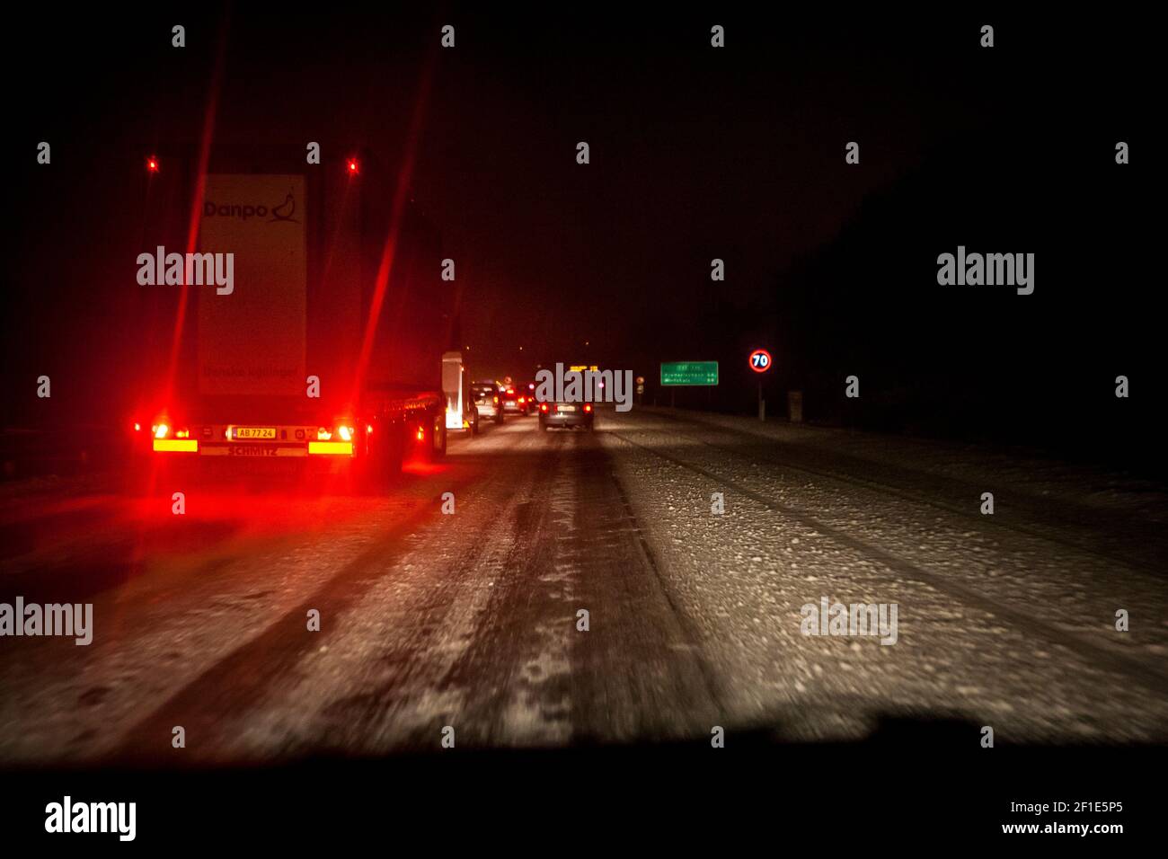 A snowy road at night on the highway Stock Photo - Alamy