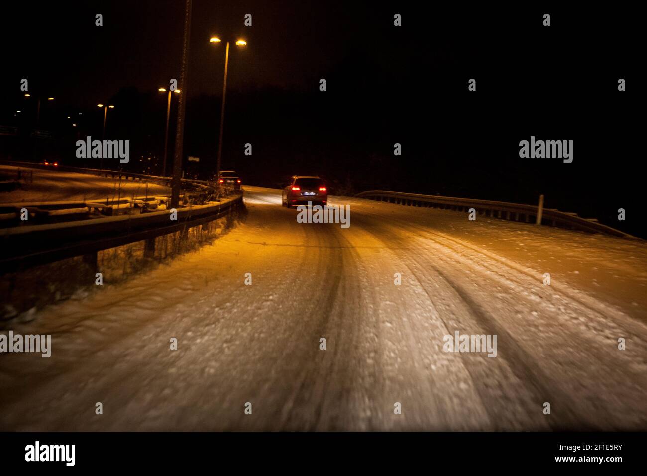 A snowy road at nighttime Stock Photo - Alamy