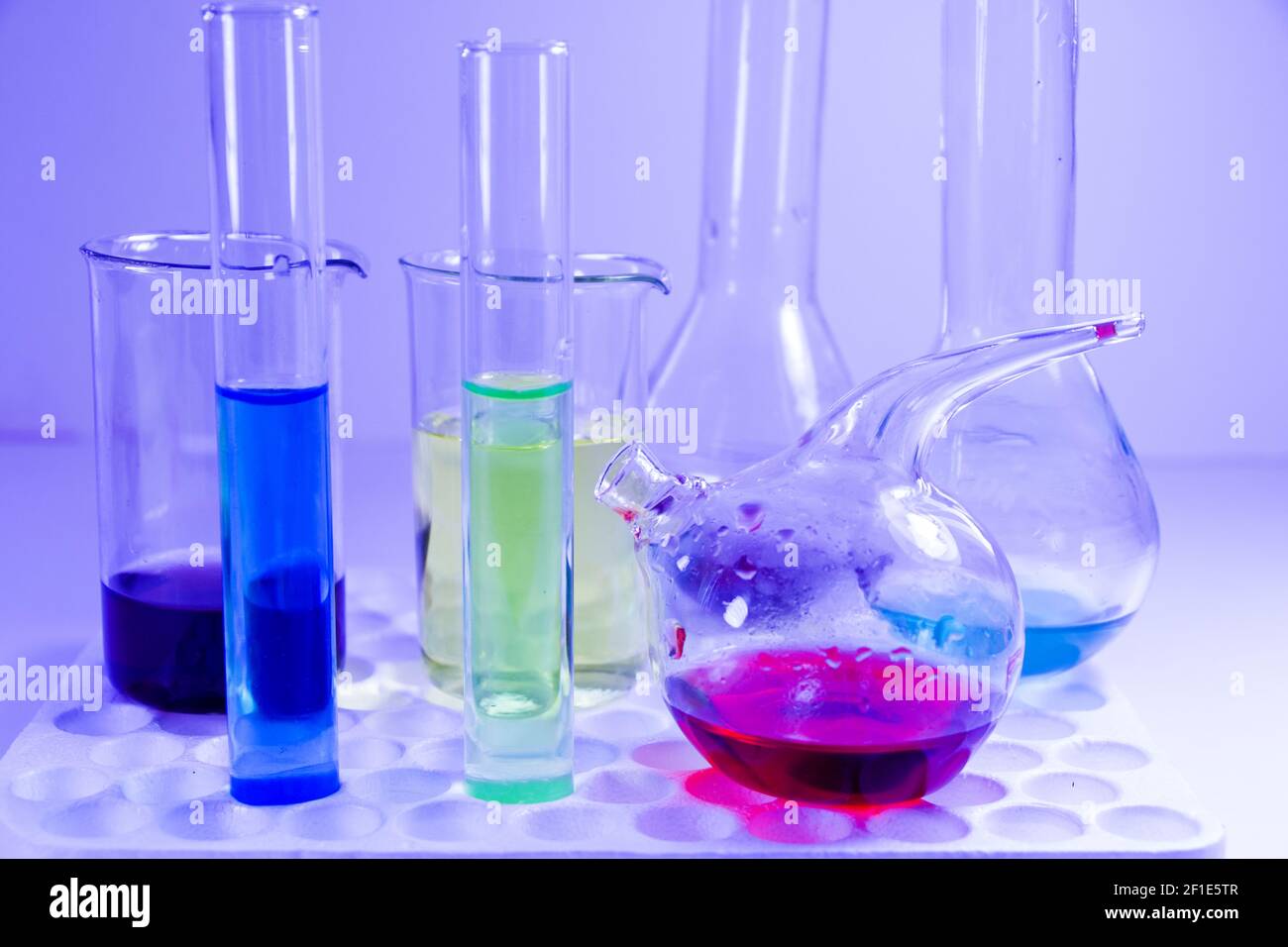 A closeup of different chemical tubes and flasks on the table in the ...