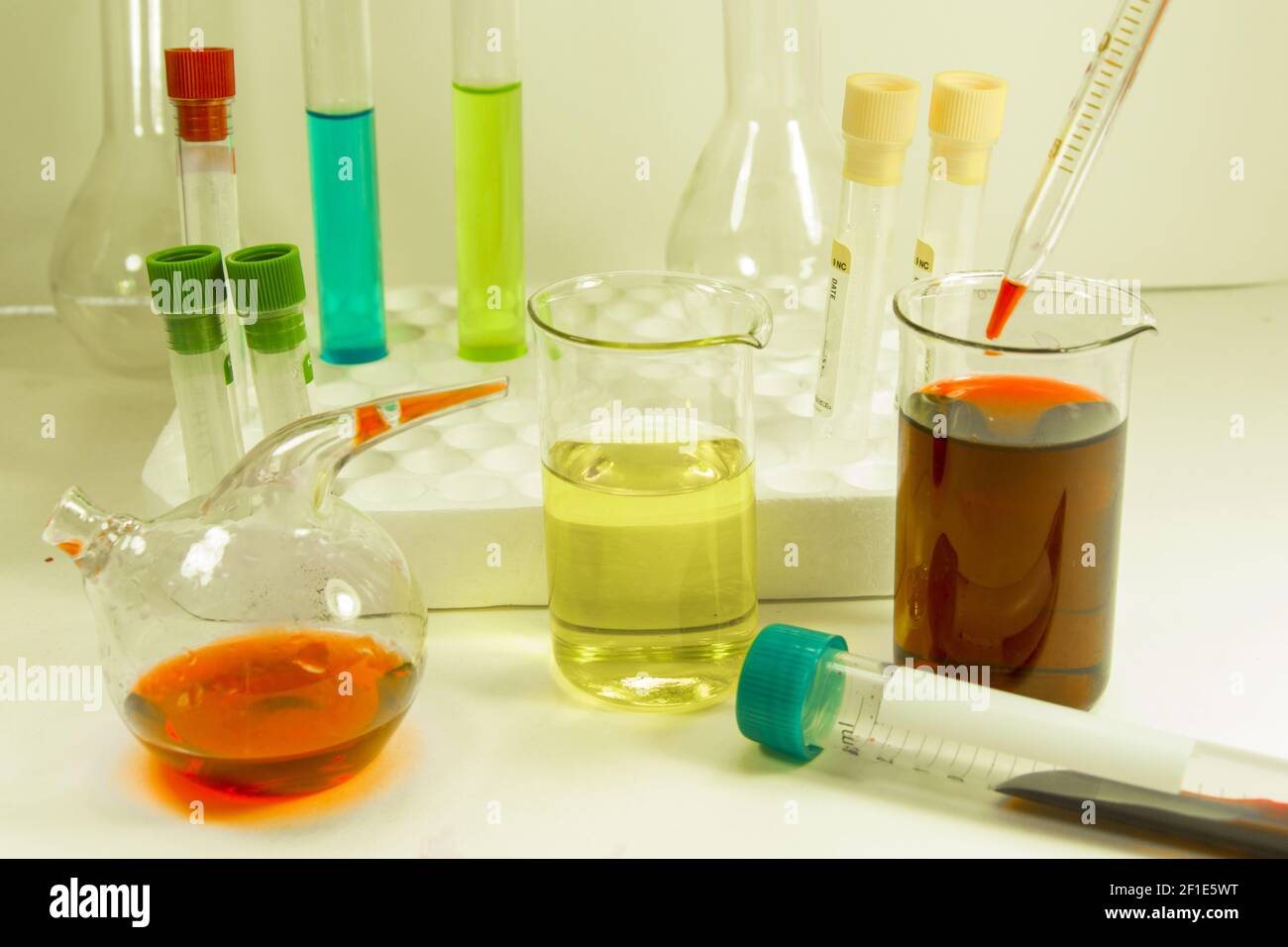 A closeup of different chemical tubes and flasks on the table in the ...