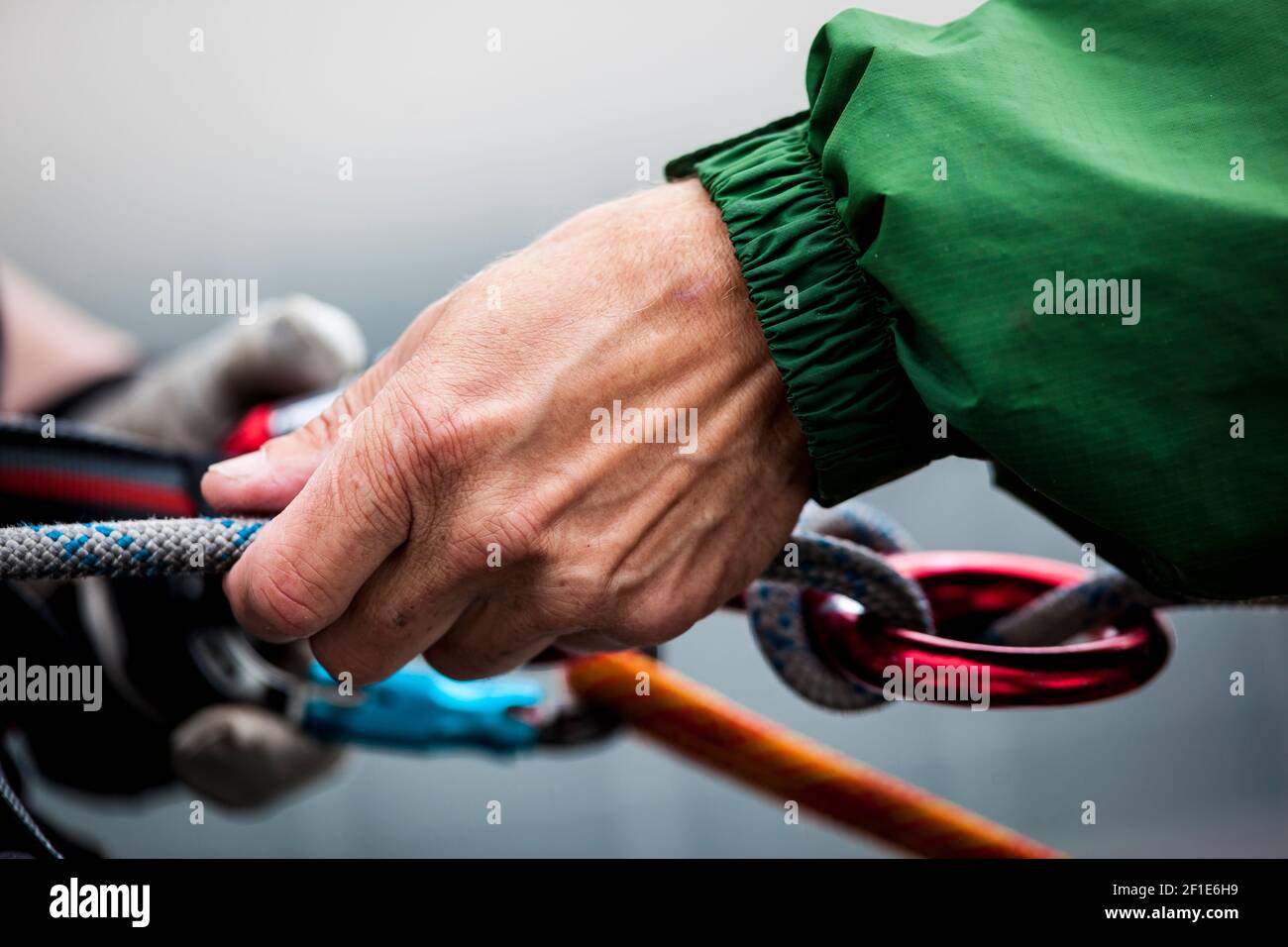 A man tying a knot in a rope Stock Photo - Alamy