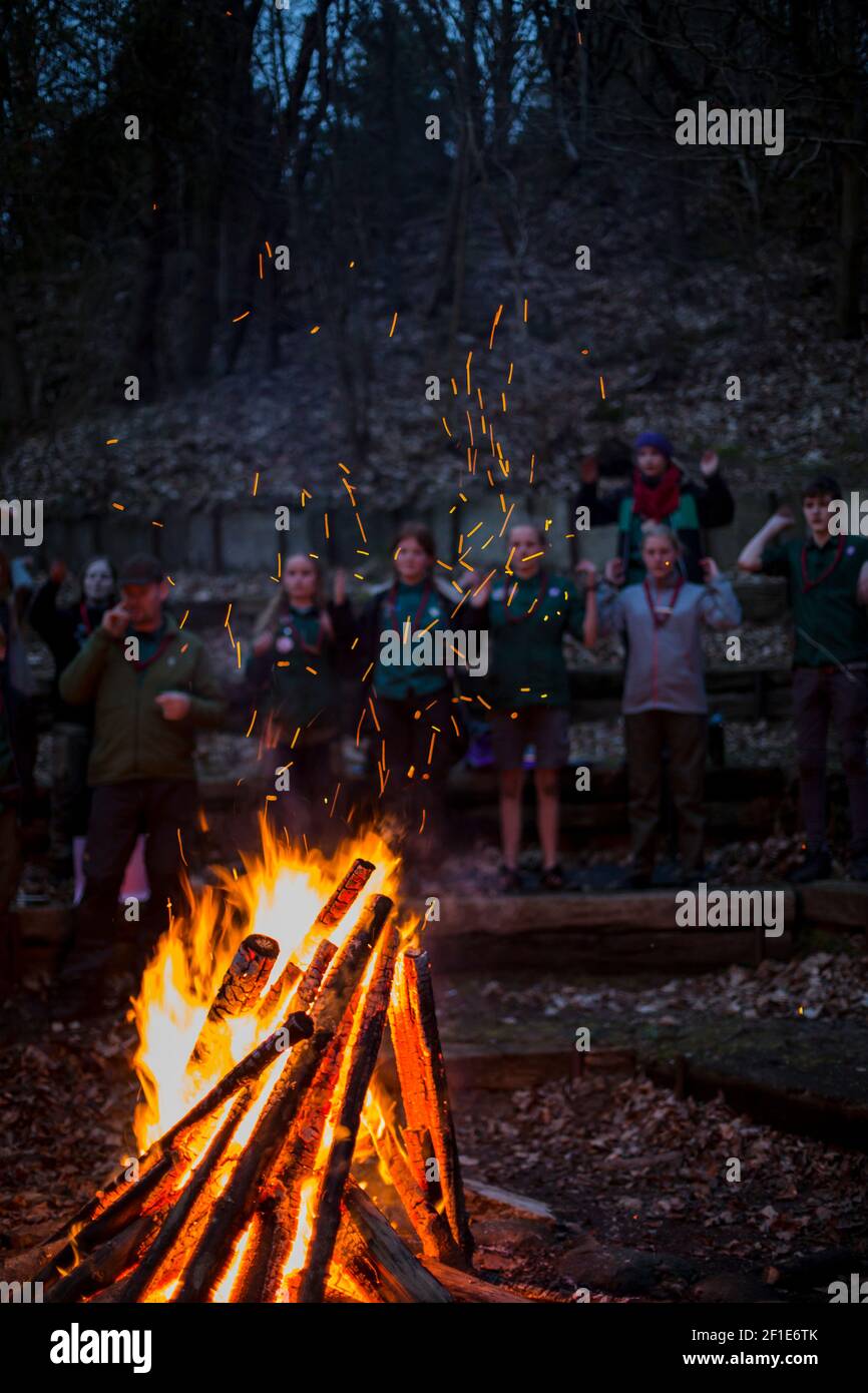 Scouts standing together around a fireplace Stock Photo - Alamy