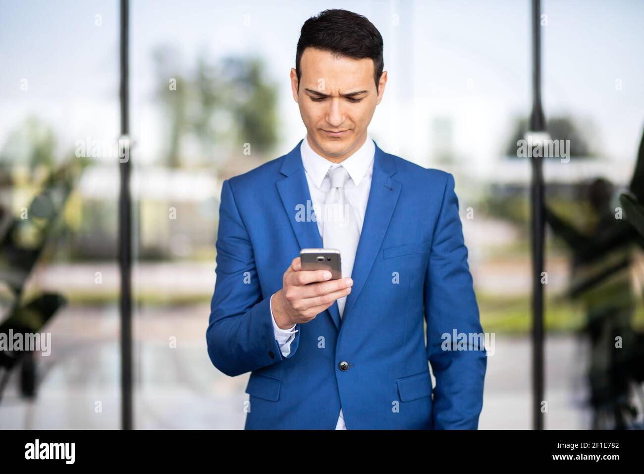 Young manager using a digital smartphone outdoor Stock Photo - Alamy