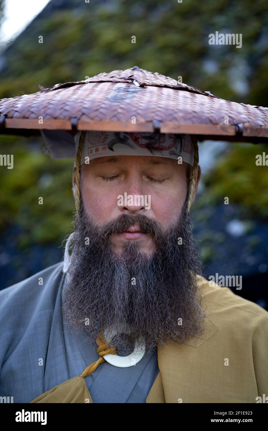 European man with beard meditates in traditional, Japanese, Shugendo ...