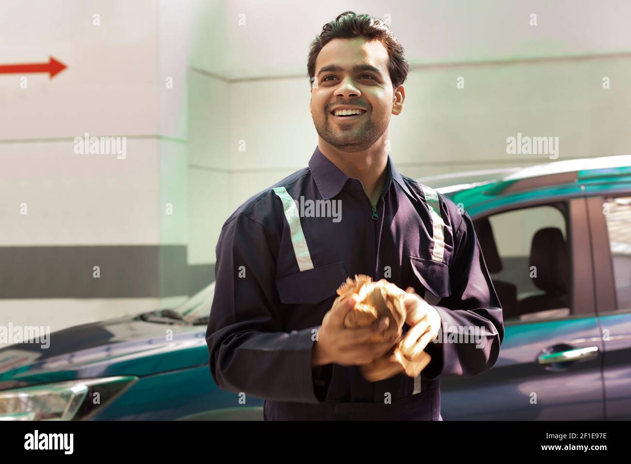 Car mechanic cleaning his hands during work at his garage, workshop ...