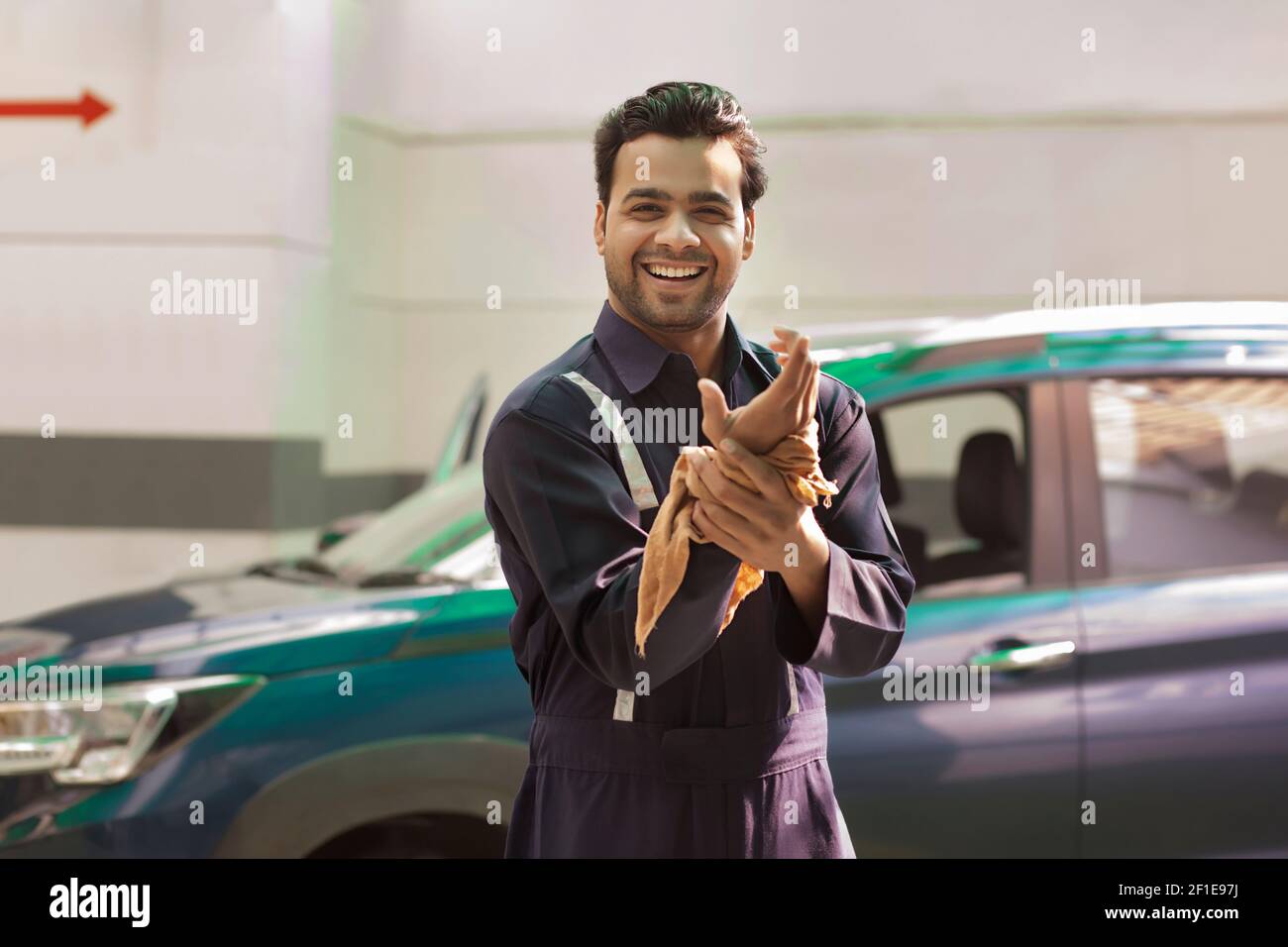 Car mechanic cleaning his hands during work at his garage, workshop ...
