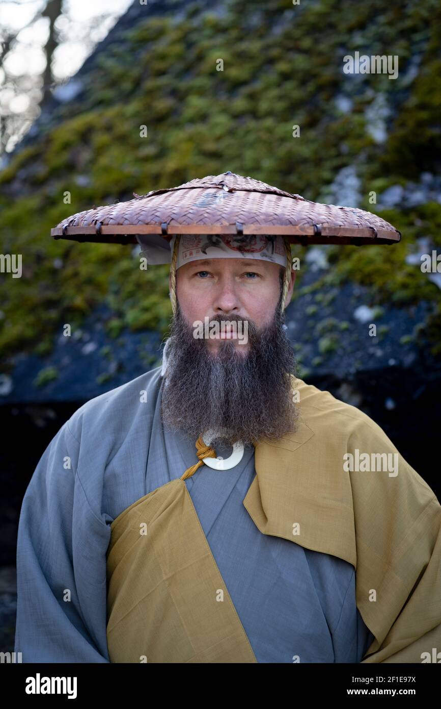 European man with beard meditates in traditional, Japanese, Shugendo ...