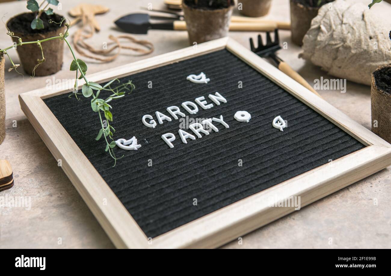 Letter board with text Garden party. Planting seeds in Biodegradable ...