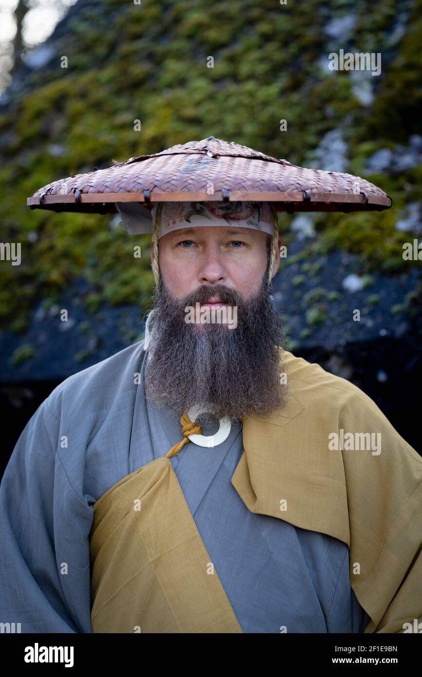 European man with beard meditates in traditional, Japanese, Shugendo ...