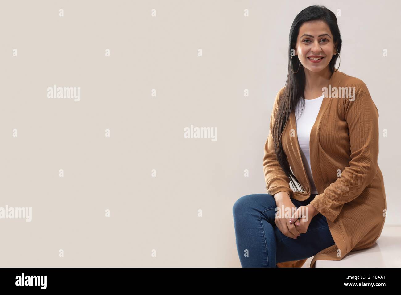 PORTRAIT OF AN ADULT WOMAN HAPPILY SITTING IN FRONT OF CAMERA Stock ...