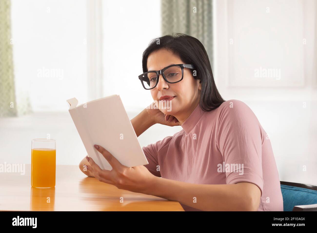 AN ADULT WOMAN SITTING ALONE AND READING BOOK Stock Photo - Alamy