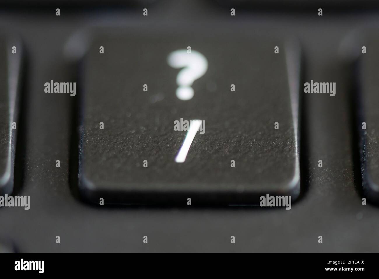 Forward slash and question mark key on a laptop keyboard Stock Photo ...