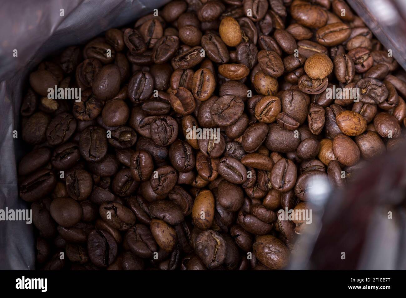 Packing with beans of coffee. aroma of fresh coffee Stock Photo - Alamy