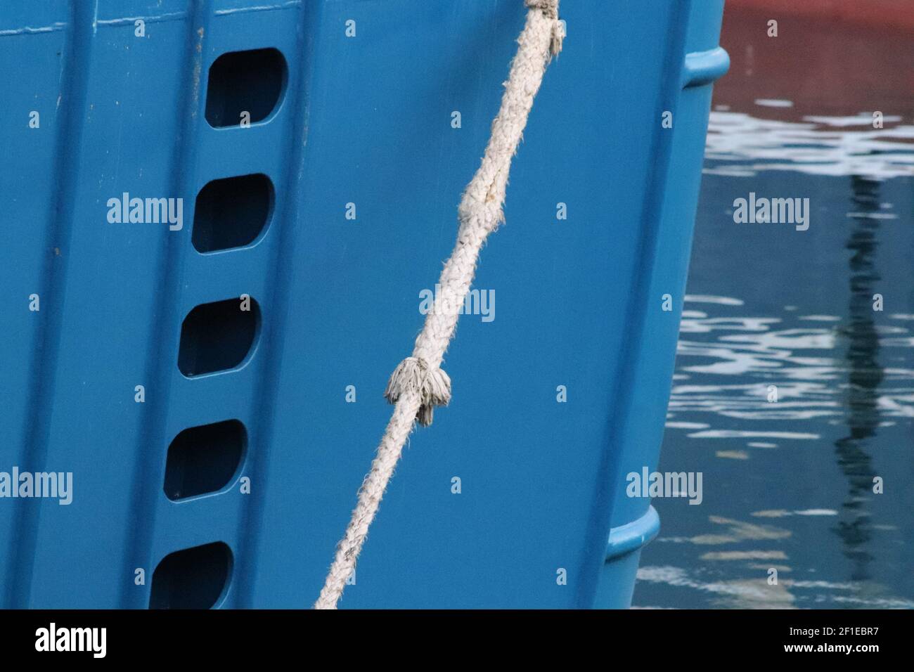 Blue hull and white rope Stock Photo - Alamy