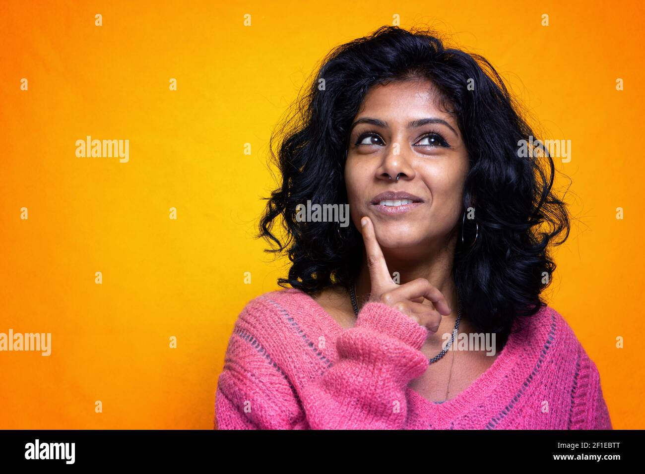 Beautiful Sri Lanka girl poses standing with yellow bright background ...