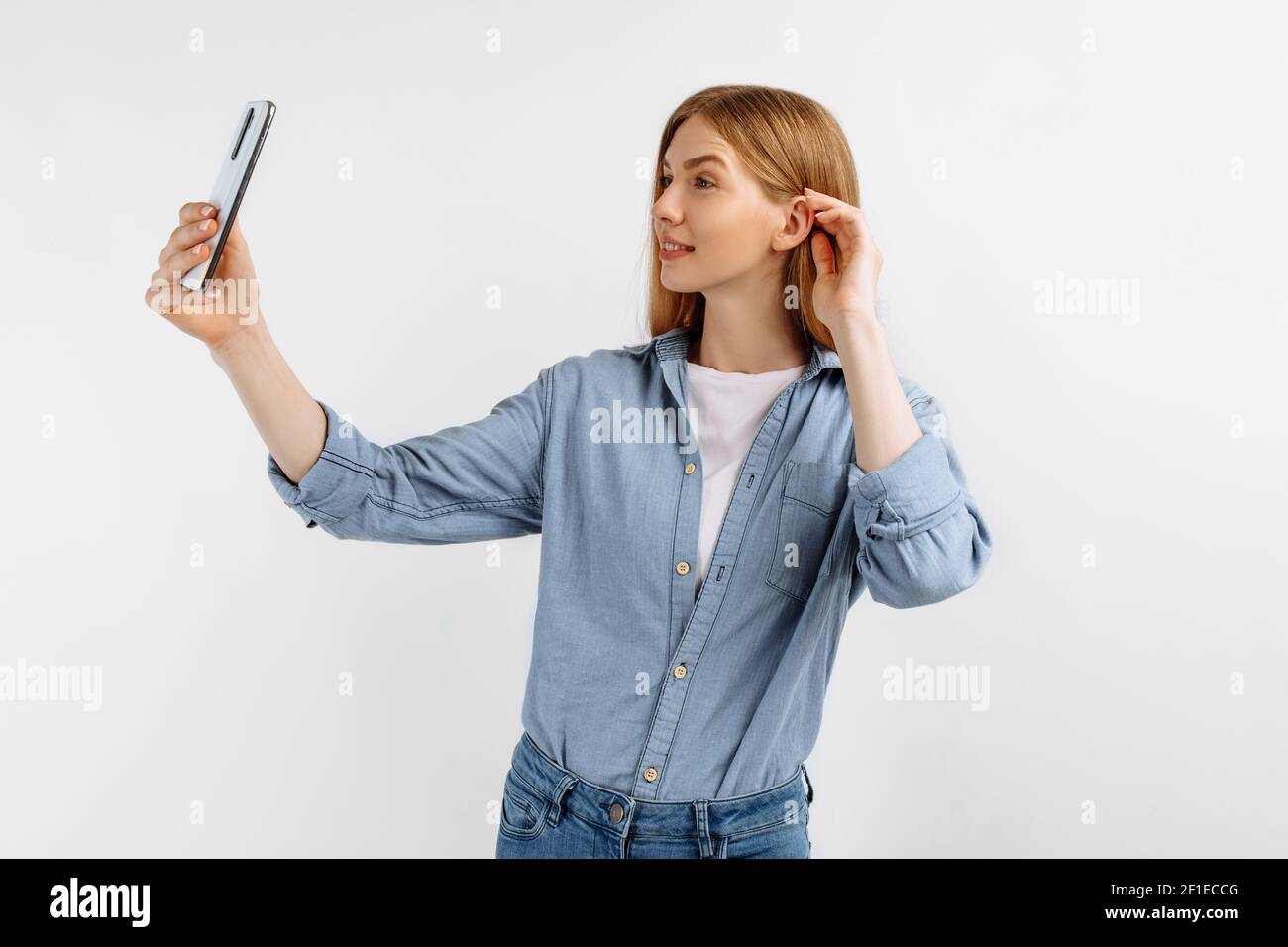 Beautiful happy young woman taking selfie on mobile phone isolated on ...