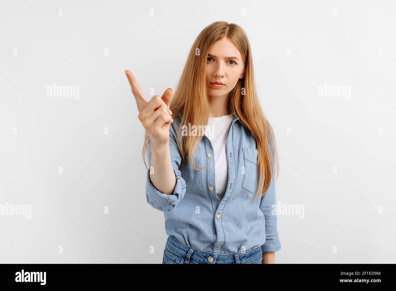 Serious young woman looking at camera makes warning sign, strict girl ...