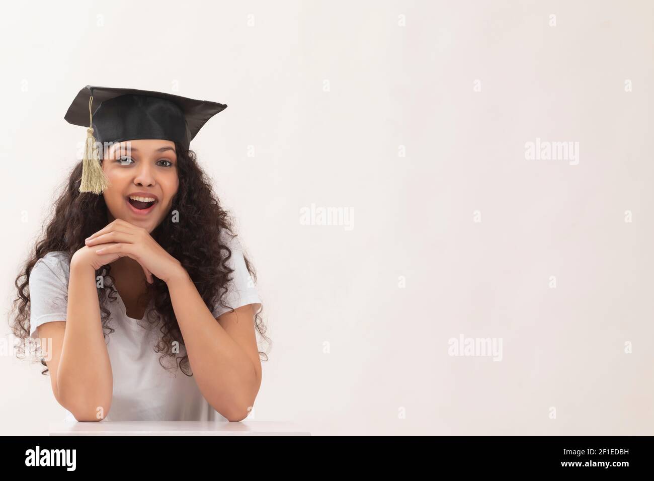 A HAPPY TEENAGER WEARING GRADUATION CAP SMILING IN SURPRISE Stock Photo ...