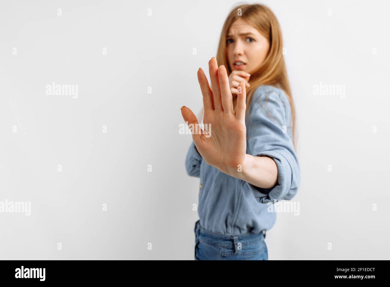 I'm afraid. Portrait of a frightened woman, on an isolated white ...