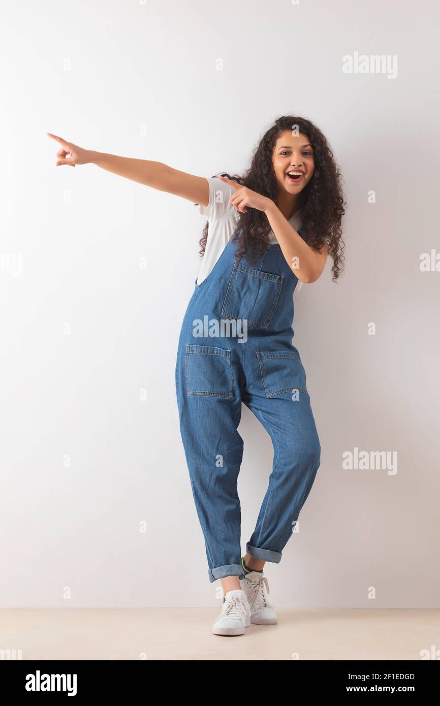 A CURLY HAIRED TEENAGER HAPPILY DANCING IN FRONT OF CAMERA Stock Photo ...