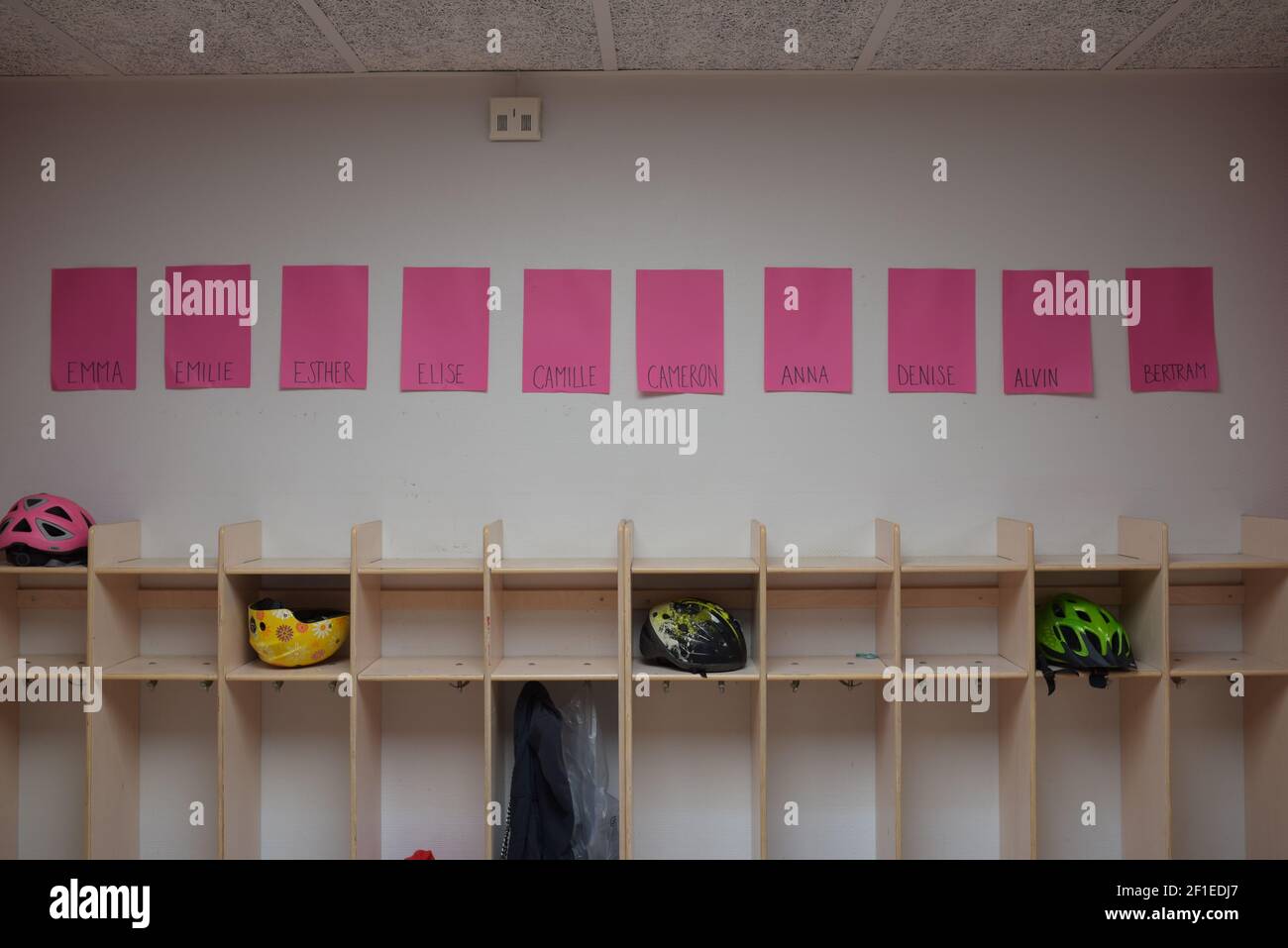Pink name signs by students lockers at a school Stock Photo - Alamy