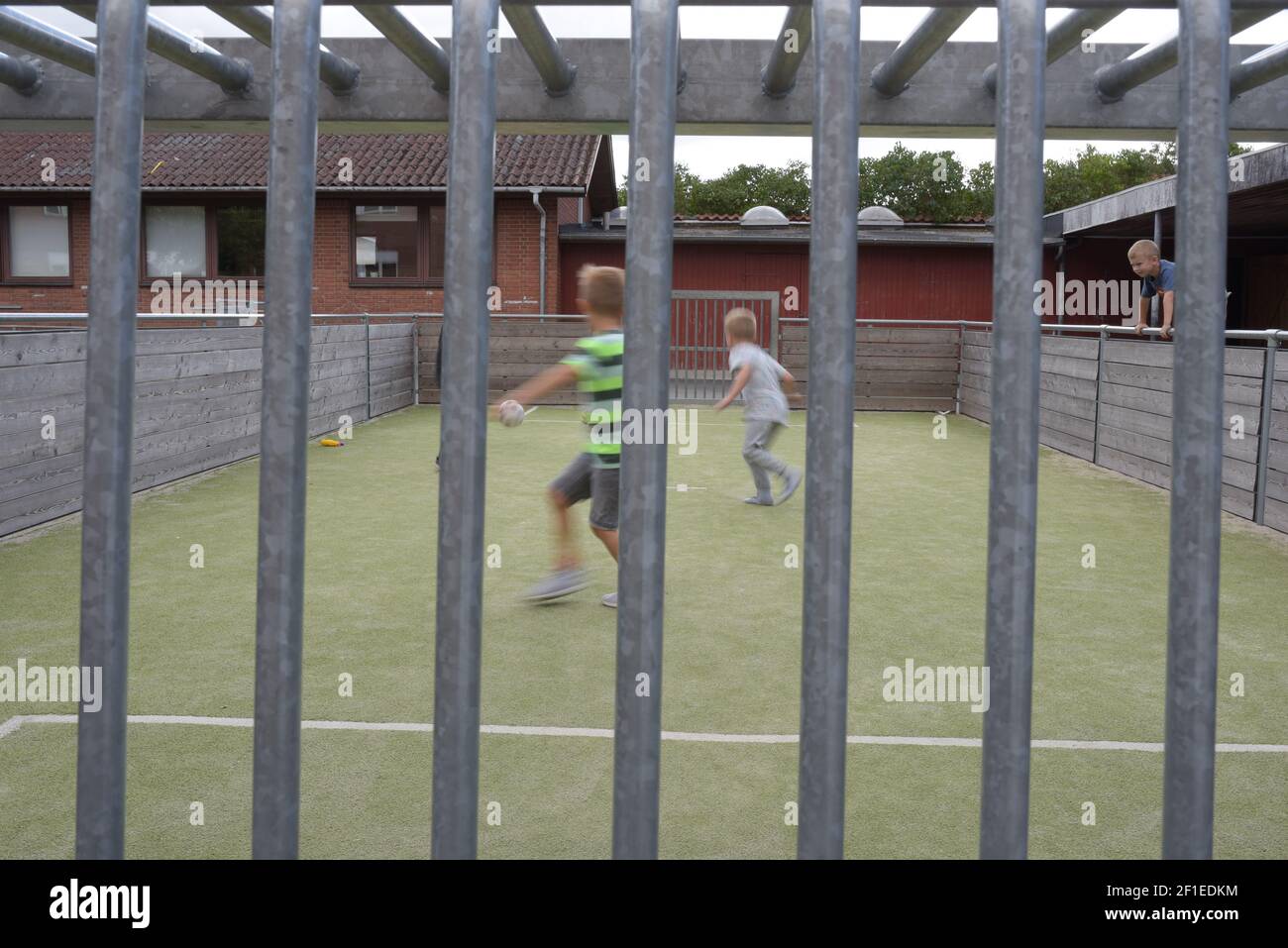 Two kids playing football on the playground at school Stock Photo - Alamy