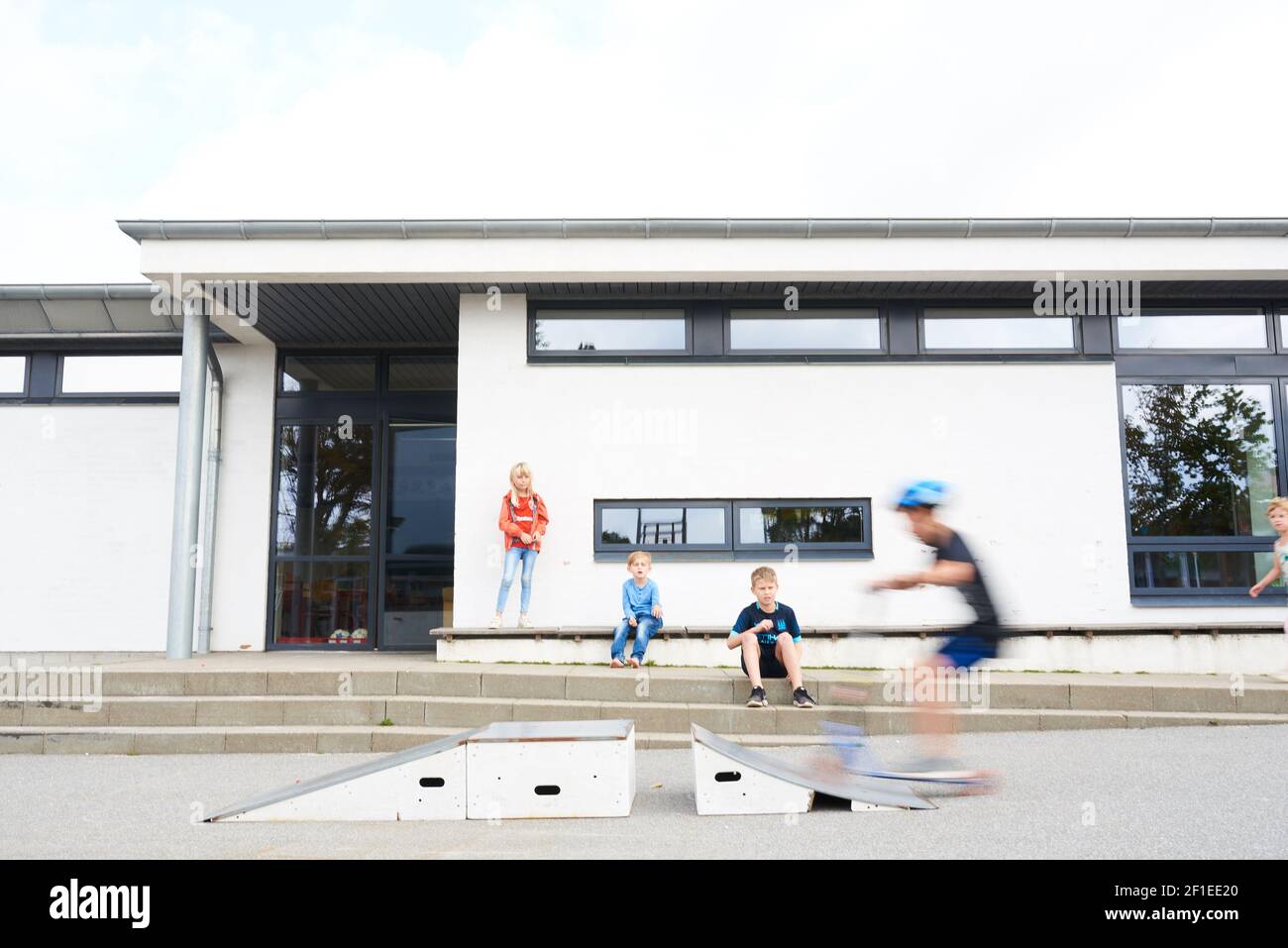Kids scooting during break at a skater-park at school Stock Photo - Alamy