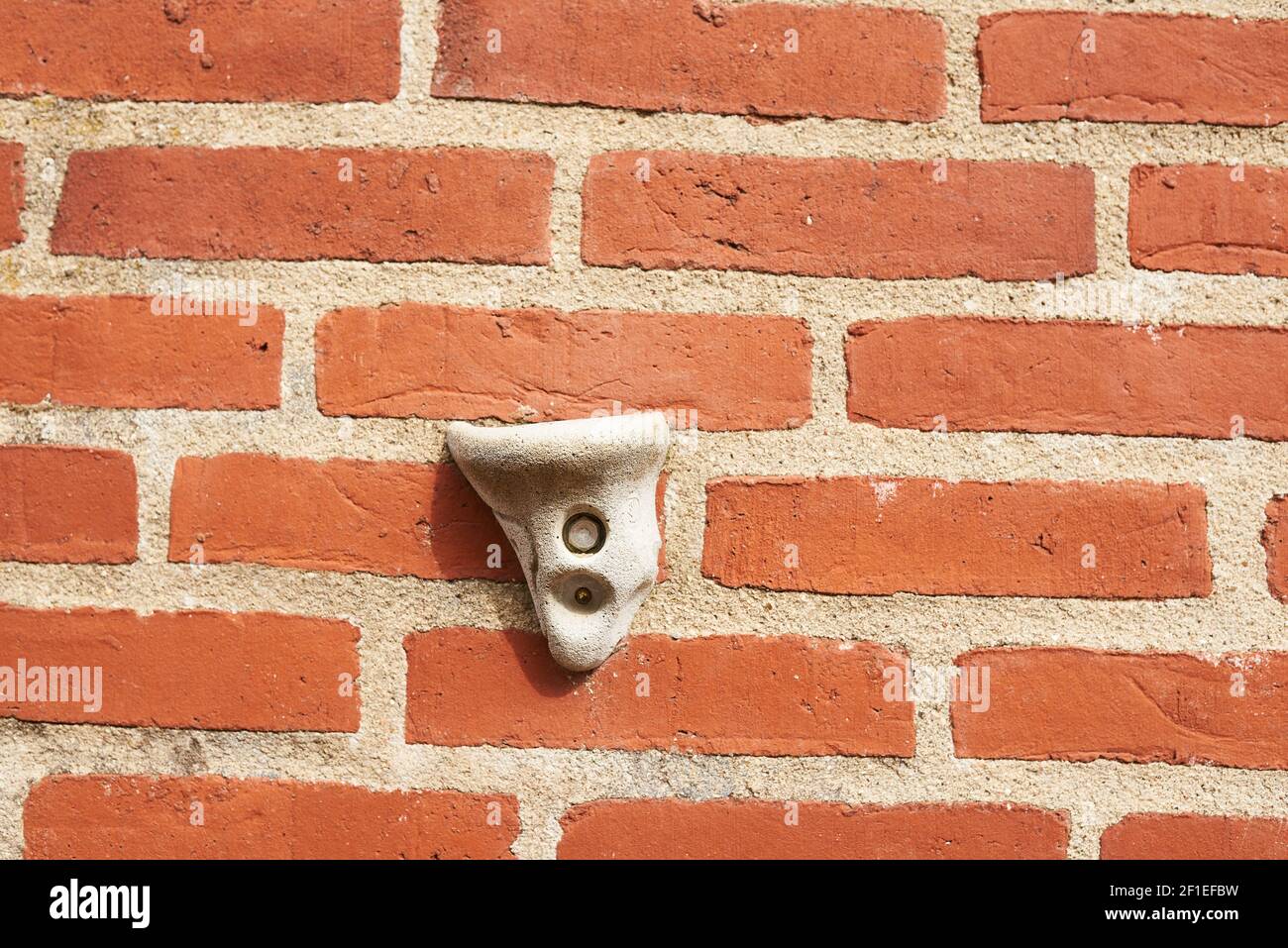 Closeup of a climbing grip on a red concrete wall Stock Photo - Alamy
