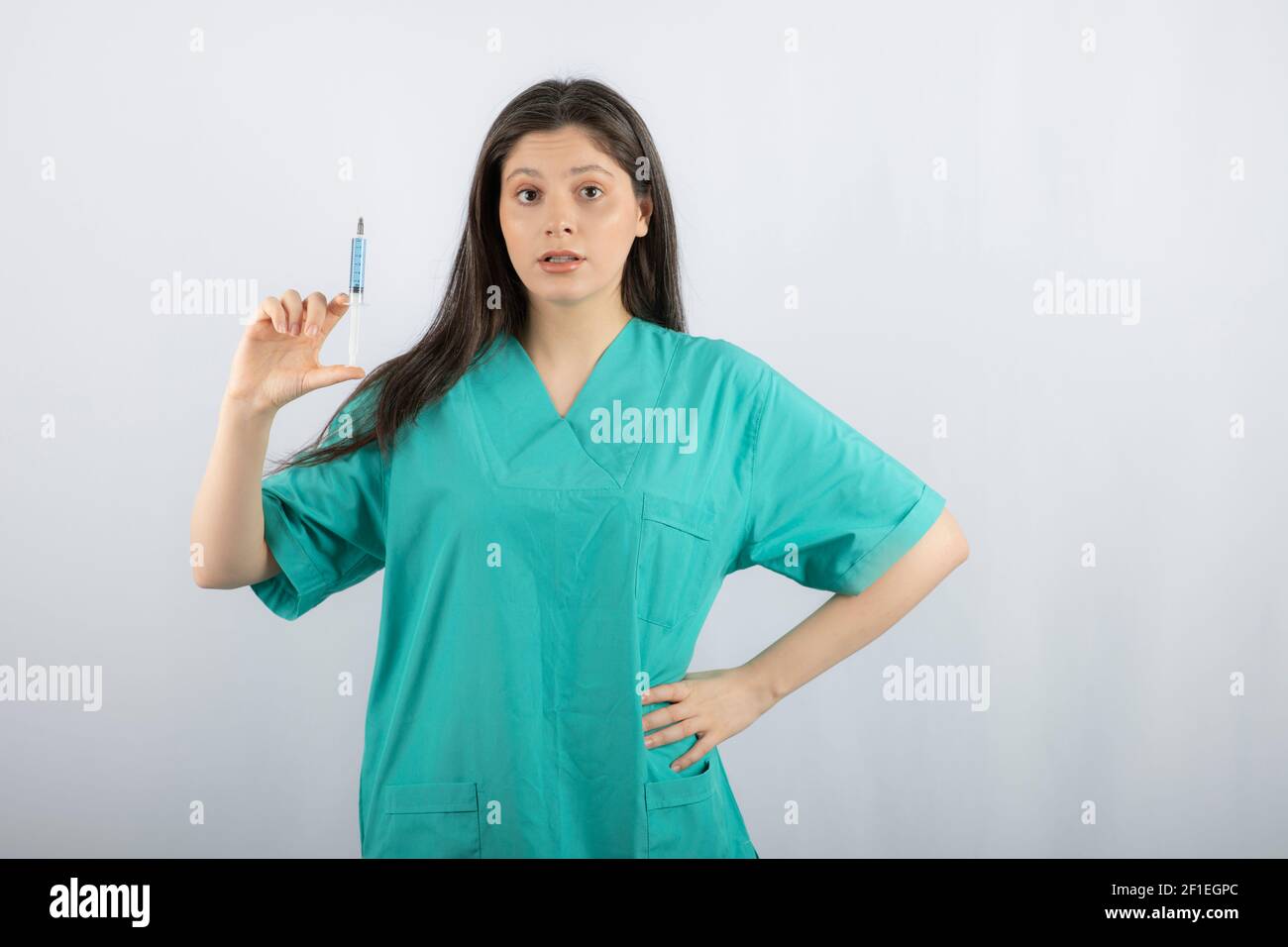 Portrait of female doctor holding a large syringe Stock Photo - Alamy
