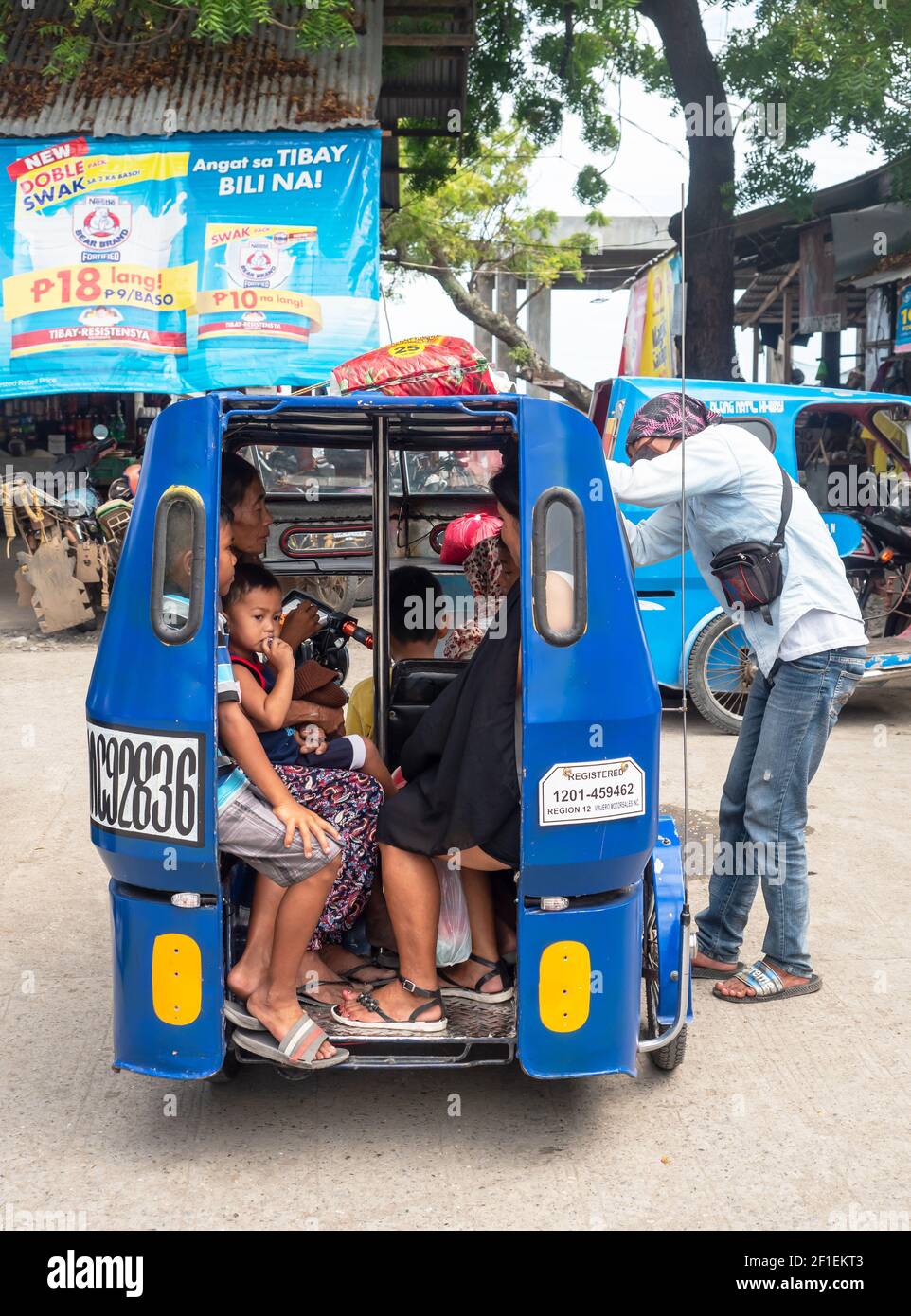 Tricycle taxi with passengers at Maasim Public Market in the Sarangani ...