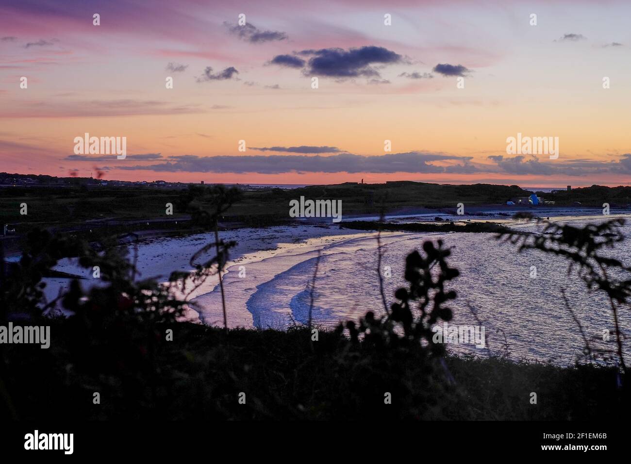 A general view of LÕAncresse Beach in Guernsey at sunset. Photo credit ...