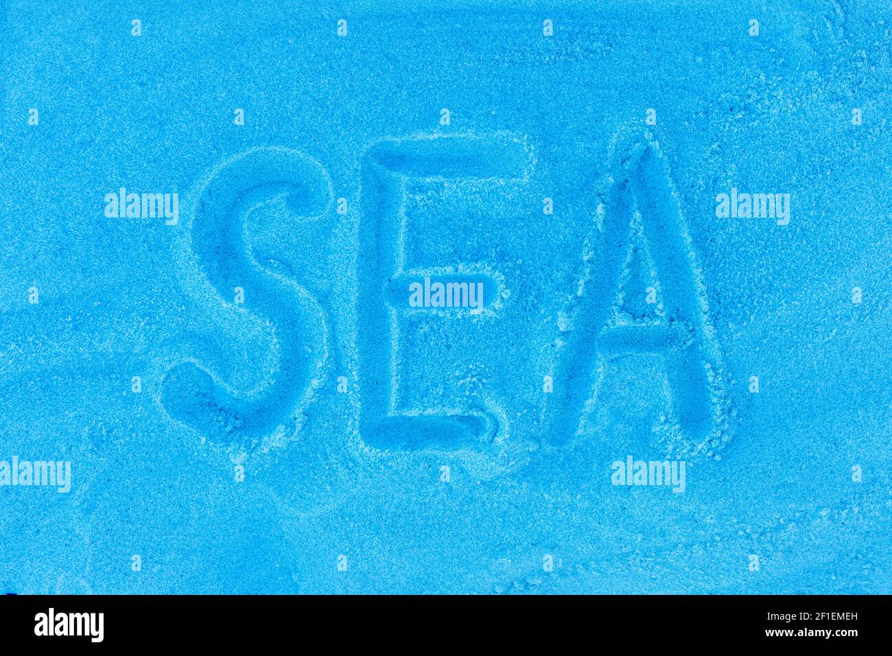 The word sea is written on a beach sand blue background. Sign or symbol ...