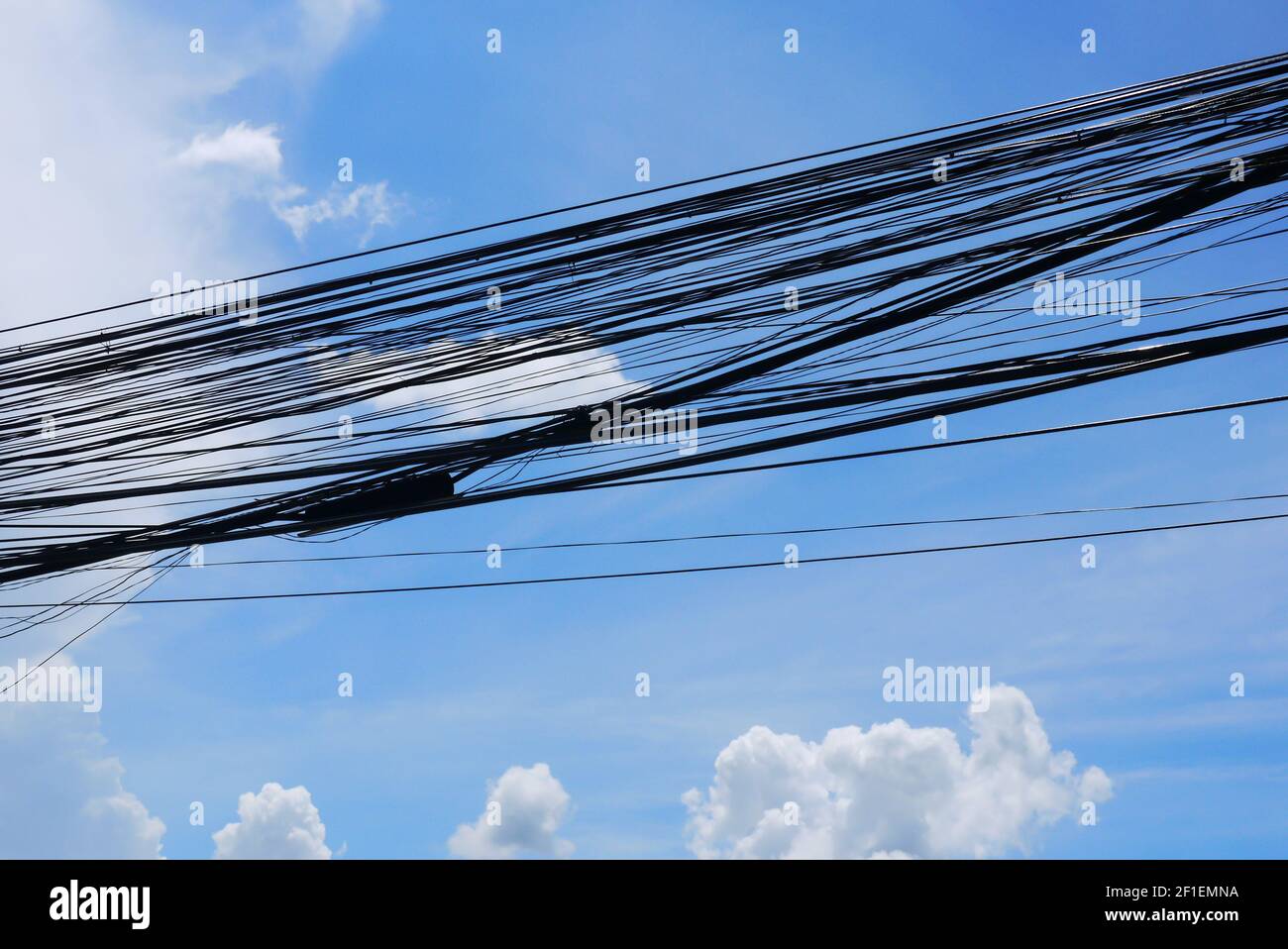 Electric cables lines with blue sky background Stock Photo - Alamy