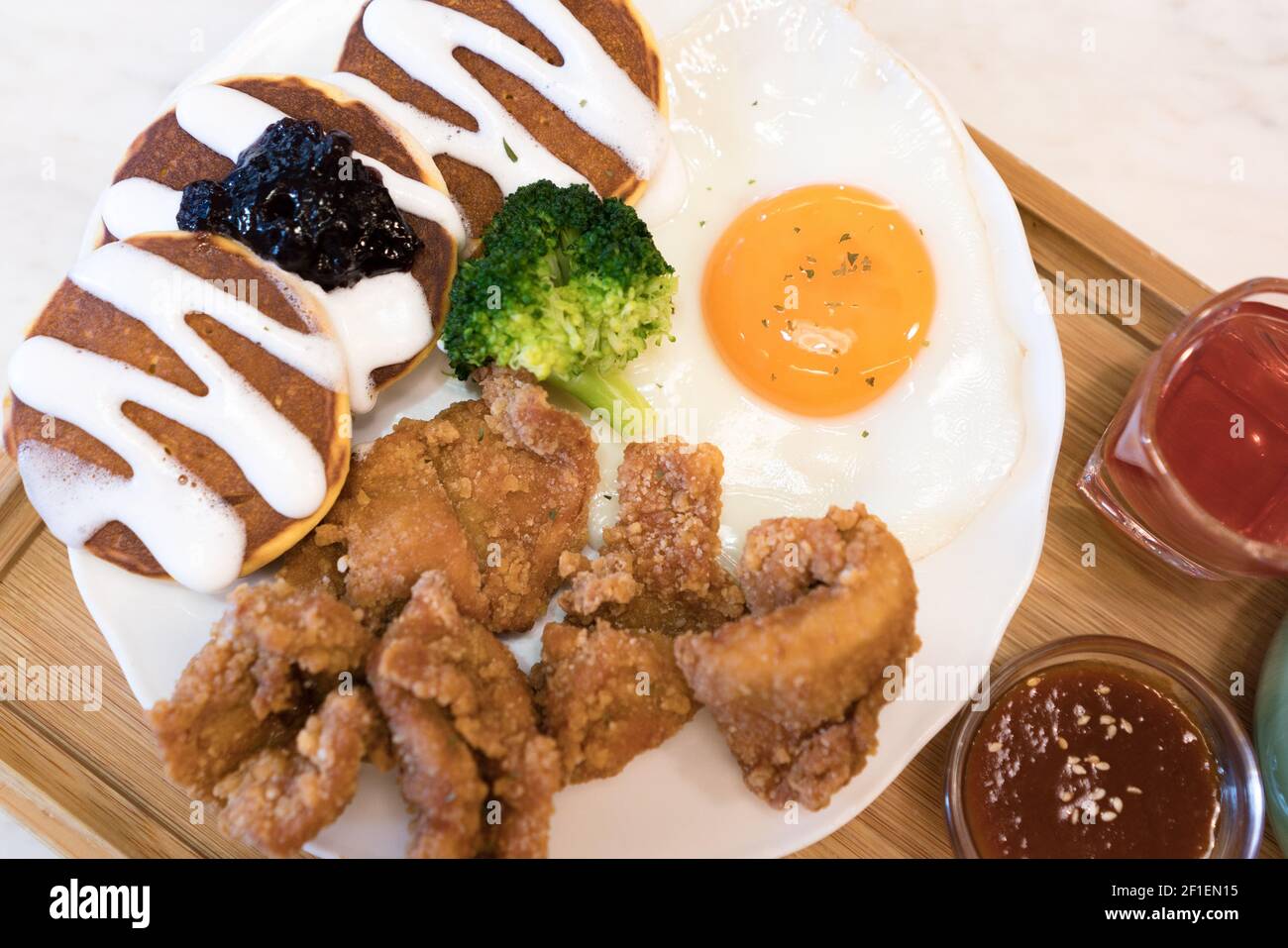 Classic USA breakfast. fried chicken, pancakes waffles, fried eggs ...