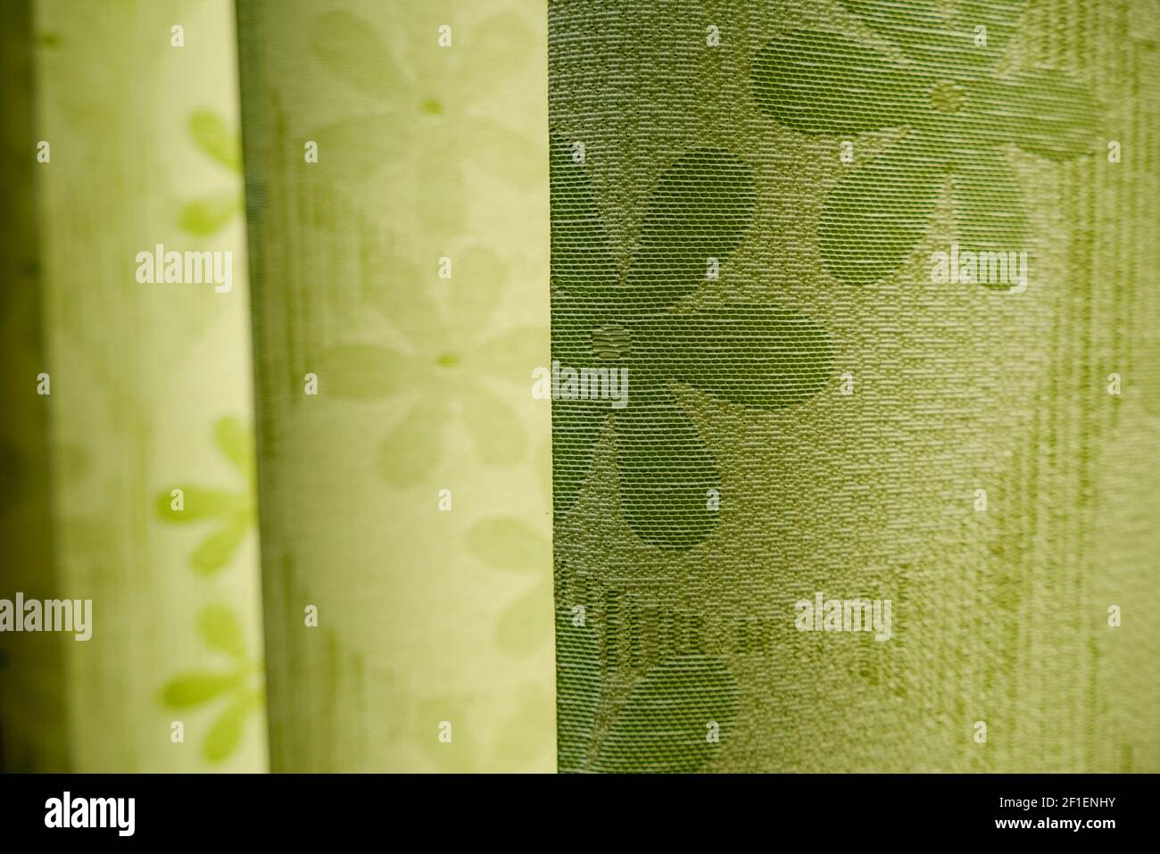 Green curtain with nuances of lights, close up on texture, fabric with ...