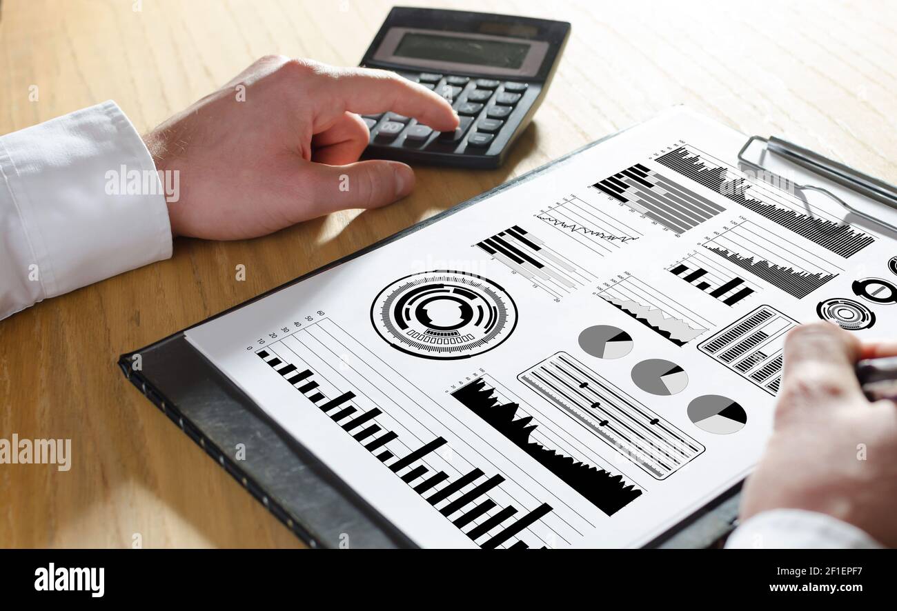 Financial analysis concept with hand using a calculator Stock Photo - Alamy