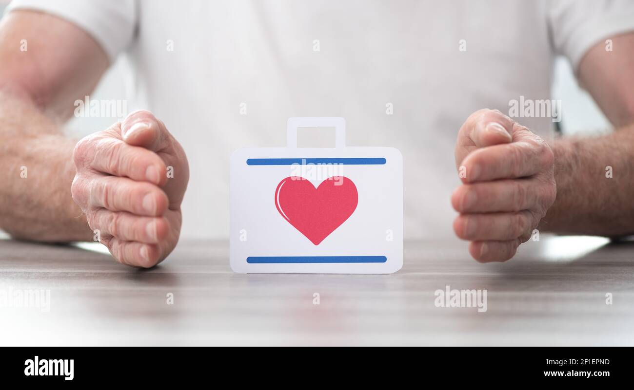 Cardiac emergency kit protected by hands - Concept of life saving Stock ...