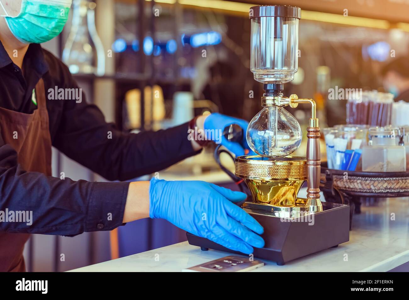 Syphon (Siphon) coffee maker brews drink using two chambers where vapor ...