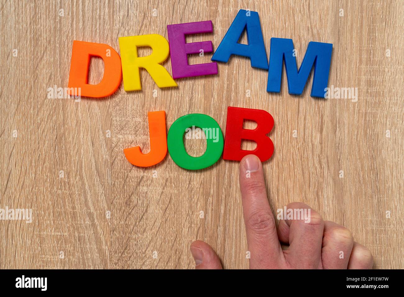 Hand and message from color letters Dream - Job Stock Photo - Alamy