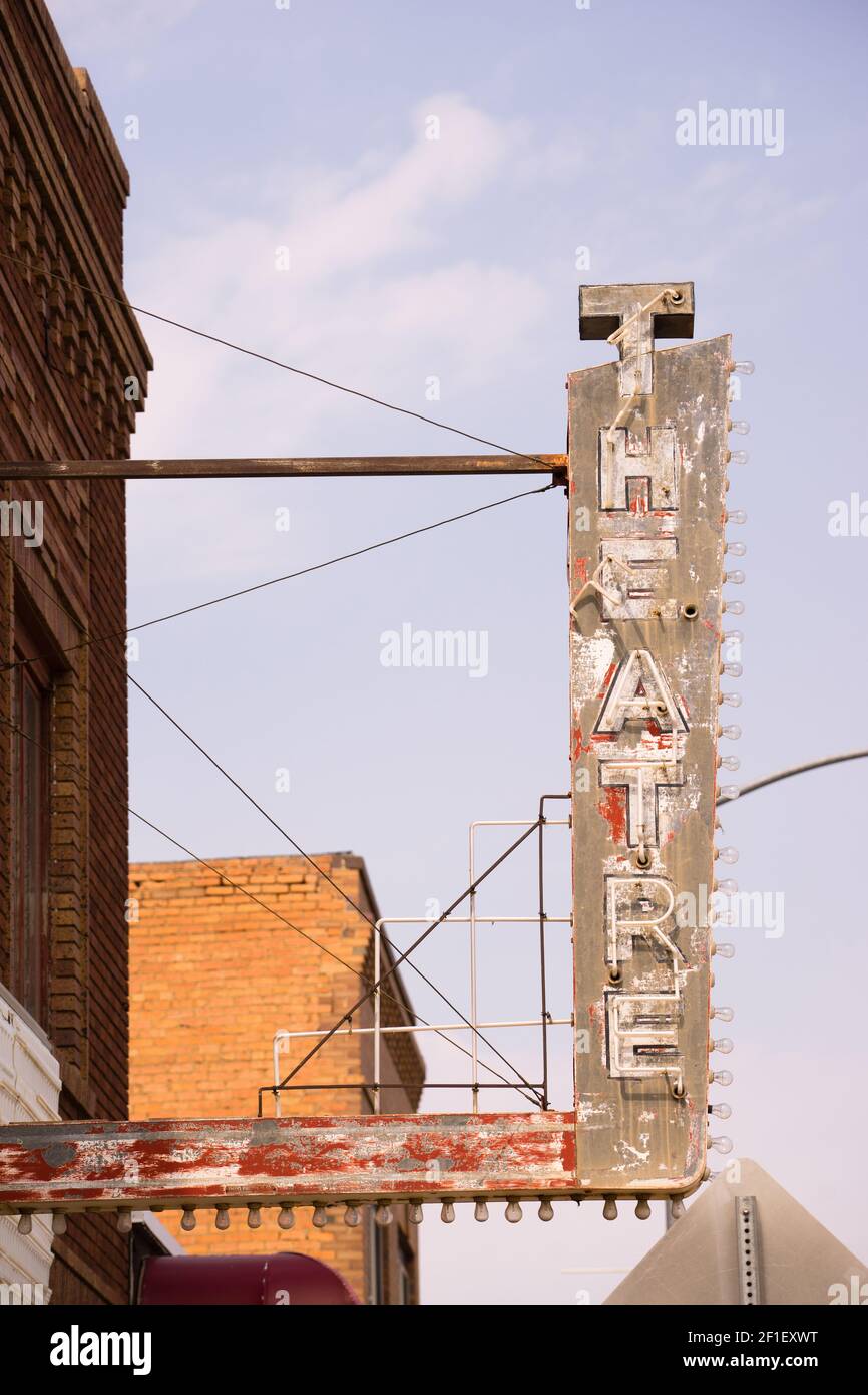 Old Vertical composition metal neon theater sign against blue sky Stock ...