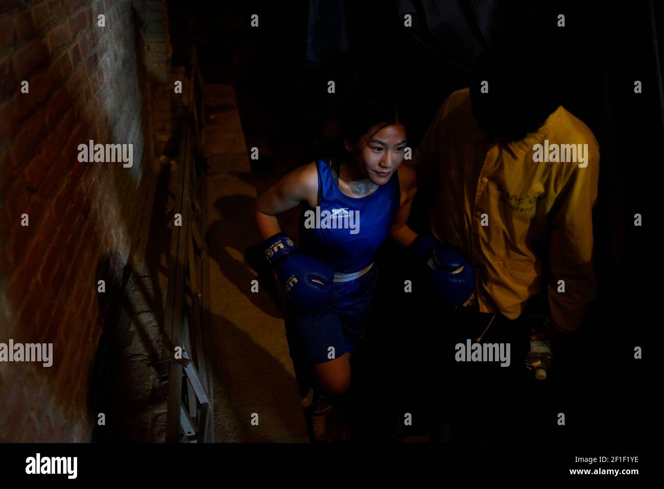 Kirtipur, Nepal. 8th Mar, 2021. A Nepalese female boxer walks to the ...