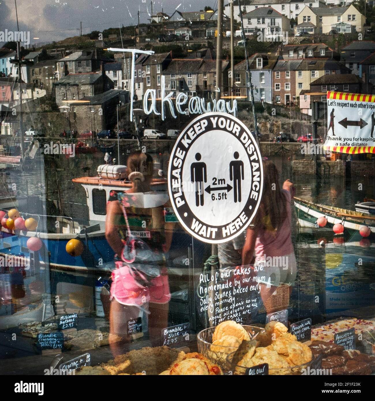 Harbour reflected in café window seaside takeaway corona virus keep ...