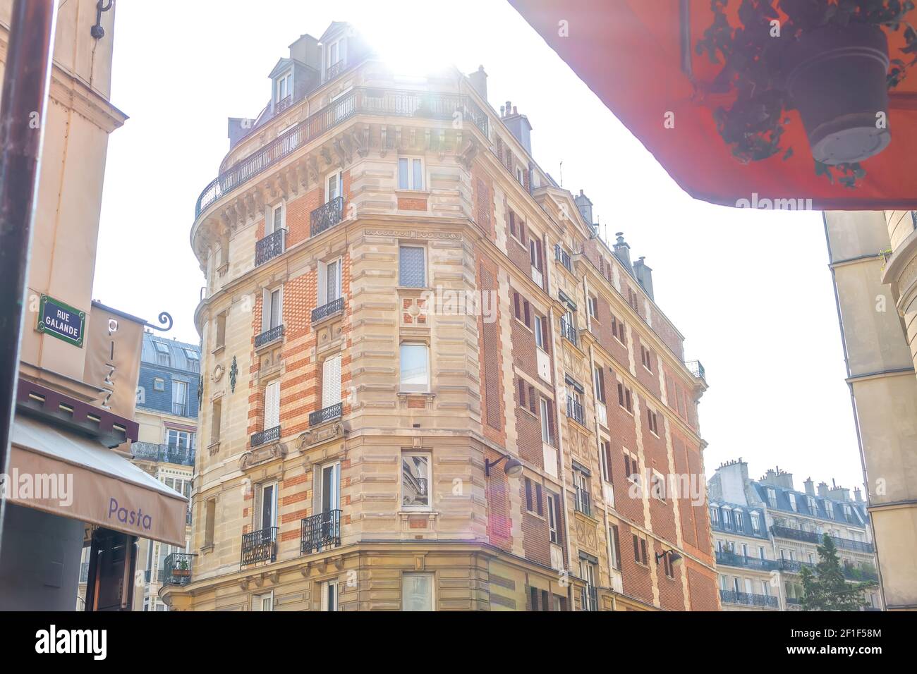 France. Sunny summer morning on Paris Galande Street. An old high-rise ...