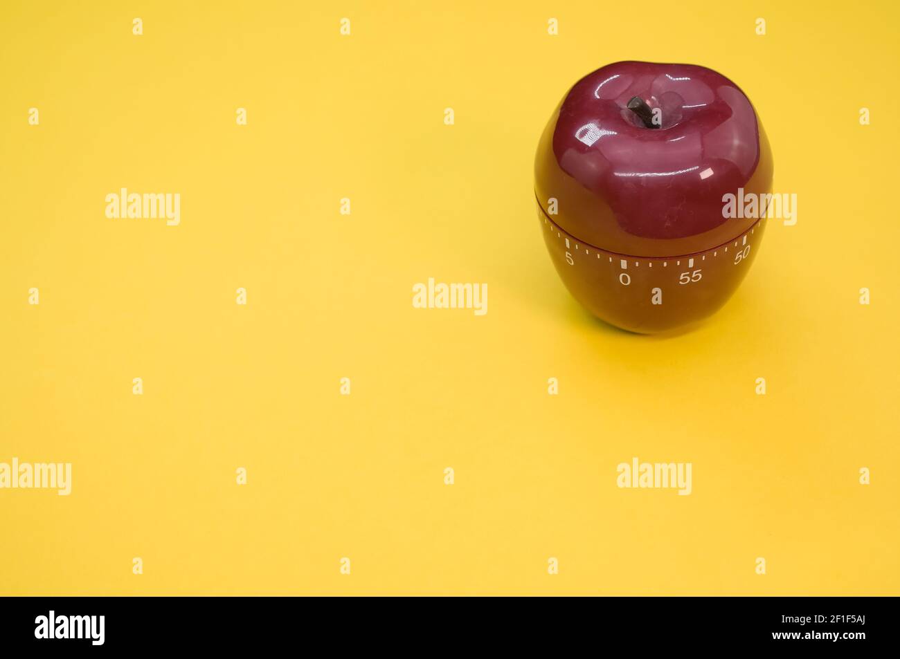 An apple-shaped kitchen timer isolated on yellow background Stock Photo ...