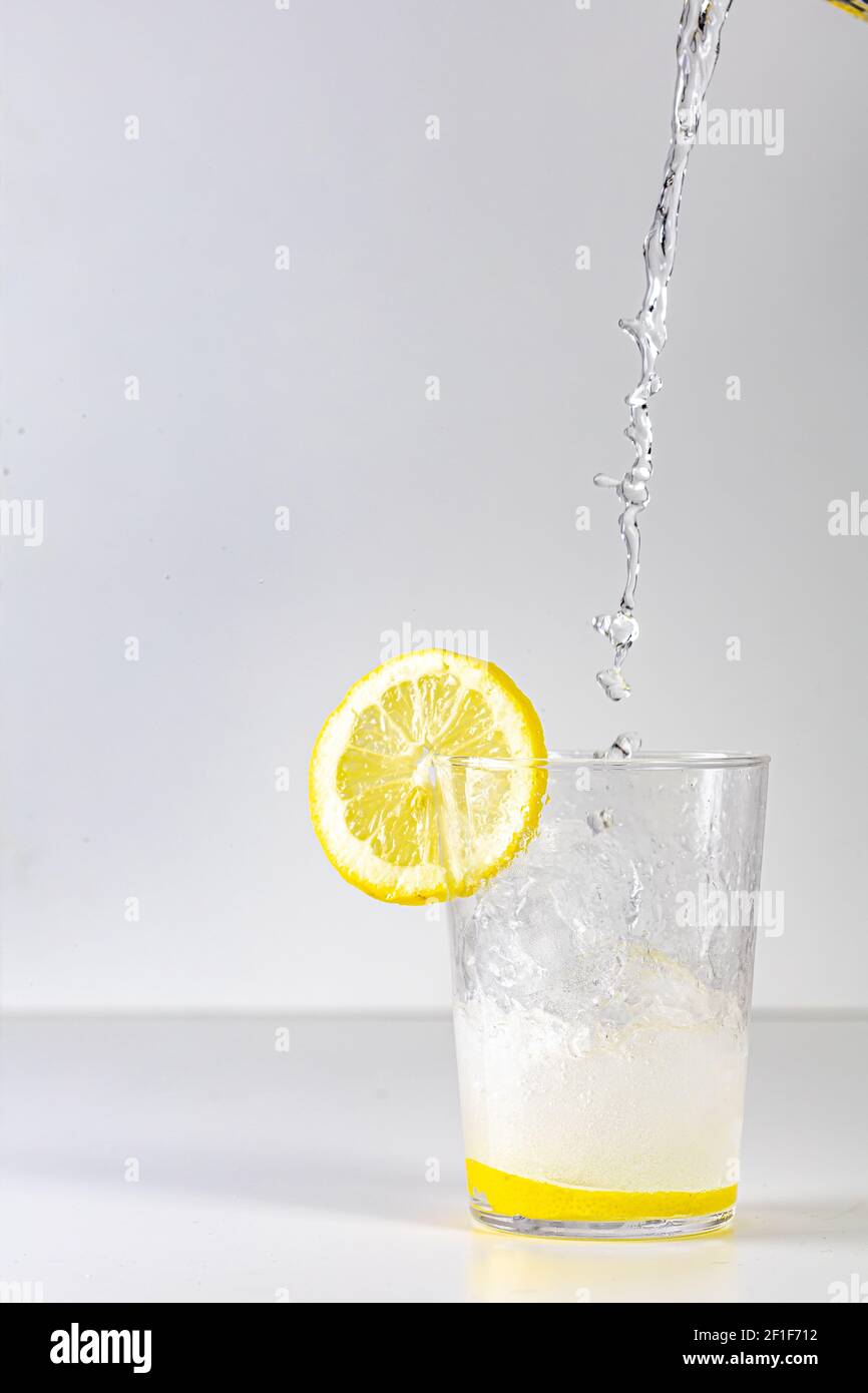 A closeup of a glass of Mauresque cocktail with a lemon slice isolated ...