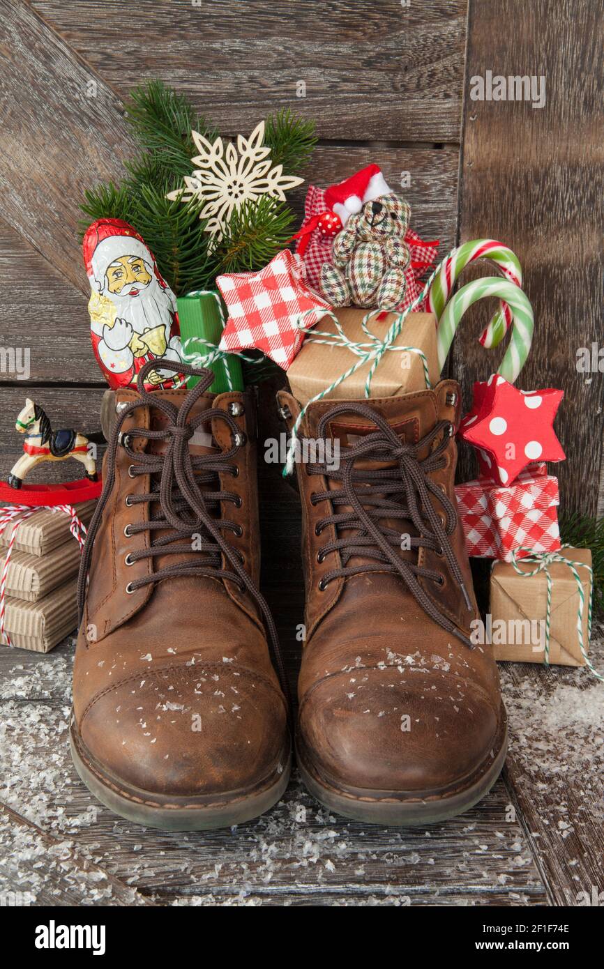 Boots with gifts and sweets Stock Photo - Alamy
